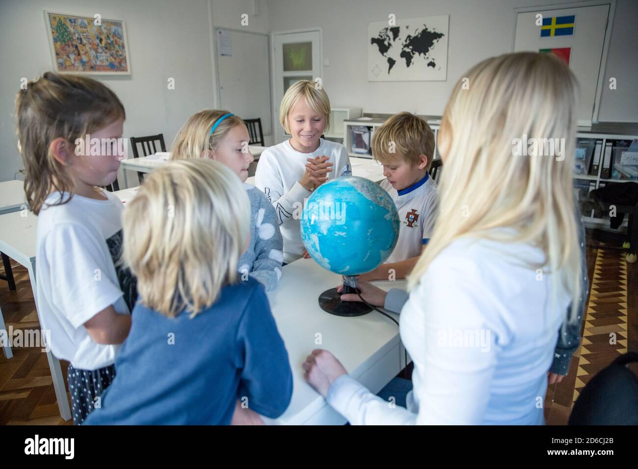 Teacher with children in classroom Stock Photo - Alamy