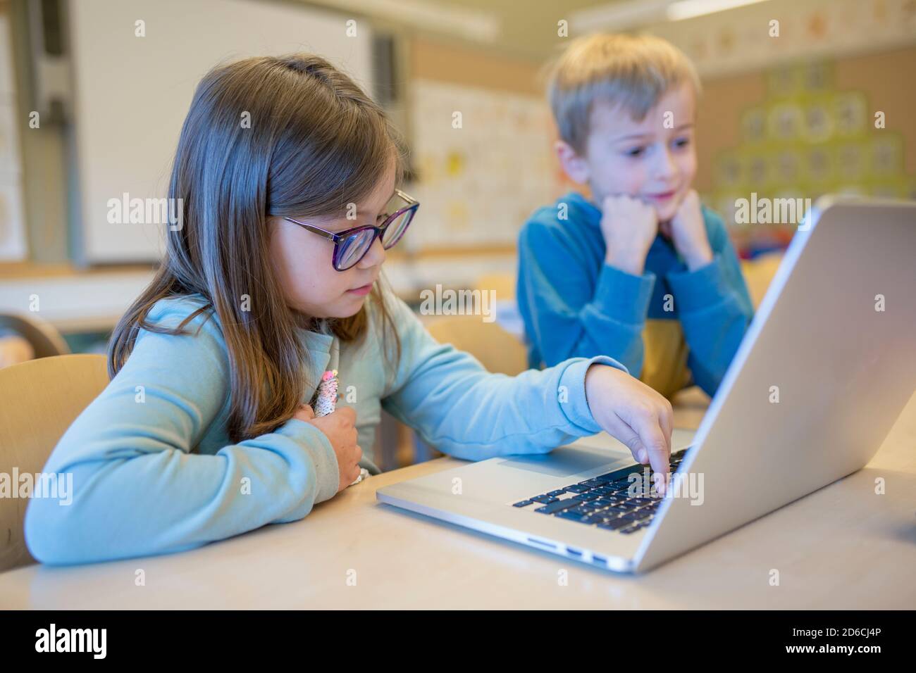 Girl using laptop in classroom Stock Photo - Alamy