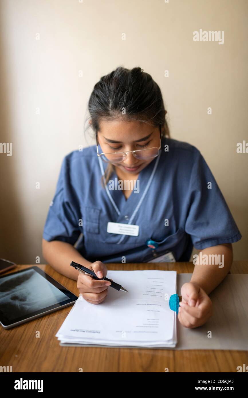 Nurse filling documents Stock Photo - Alamy