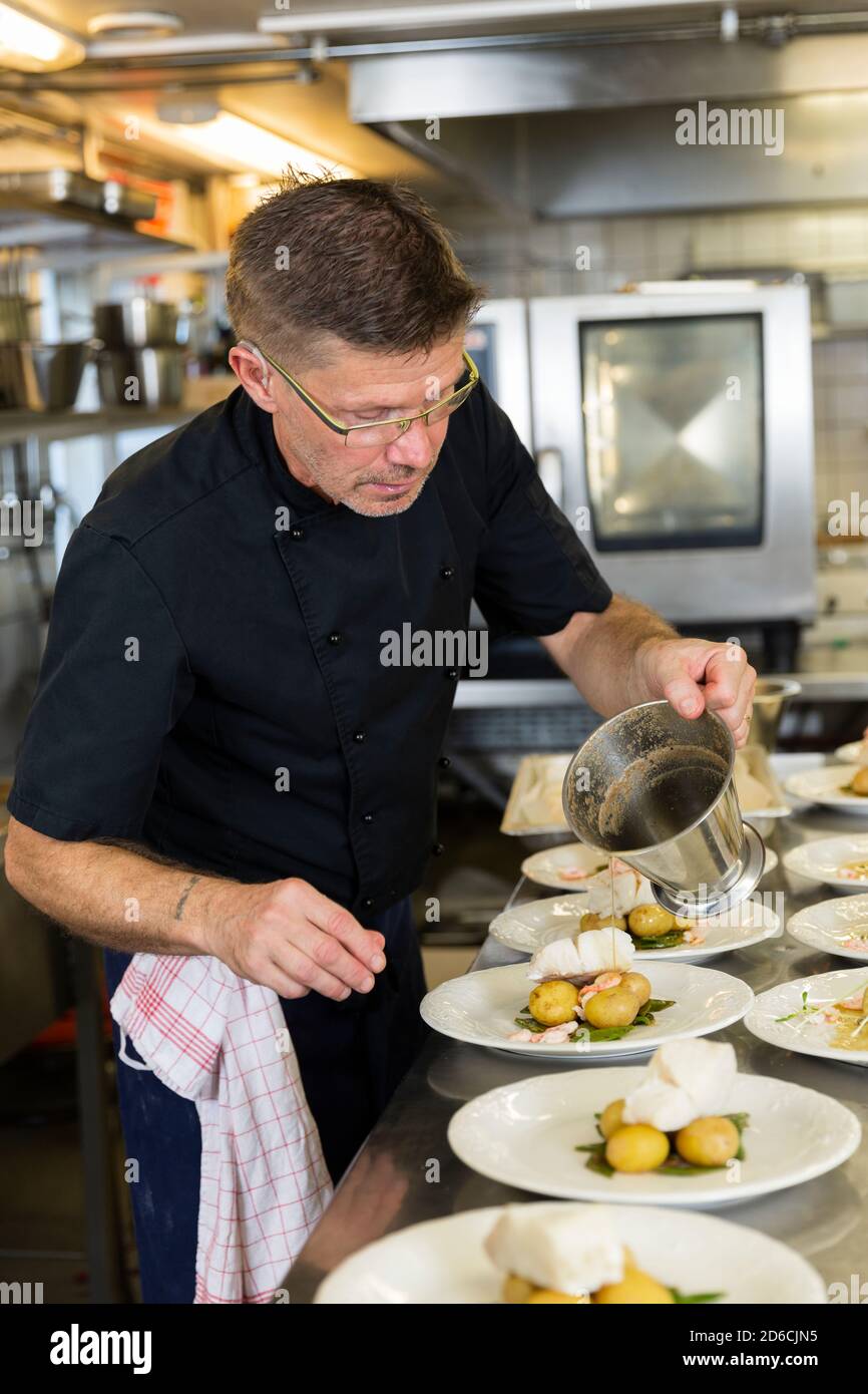Chef working in kitchen Stock Photo - Alamy
