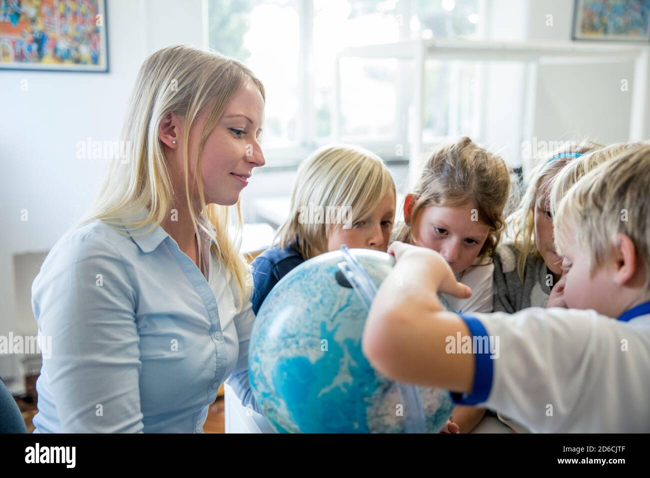 Teacher with children in classroom Stock Photo - Alamy