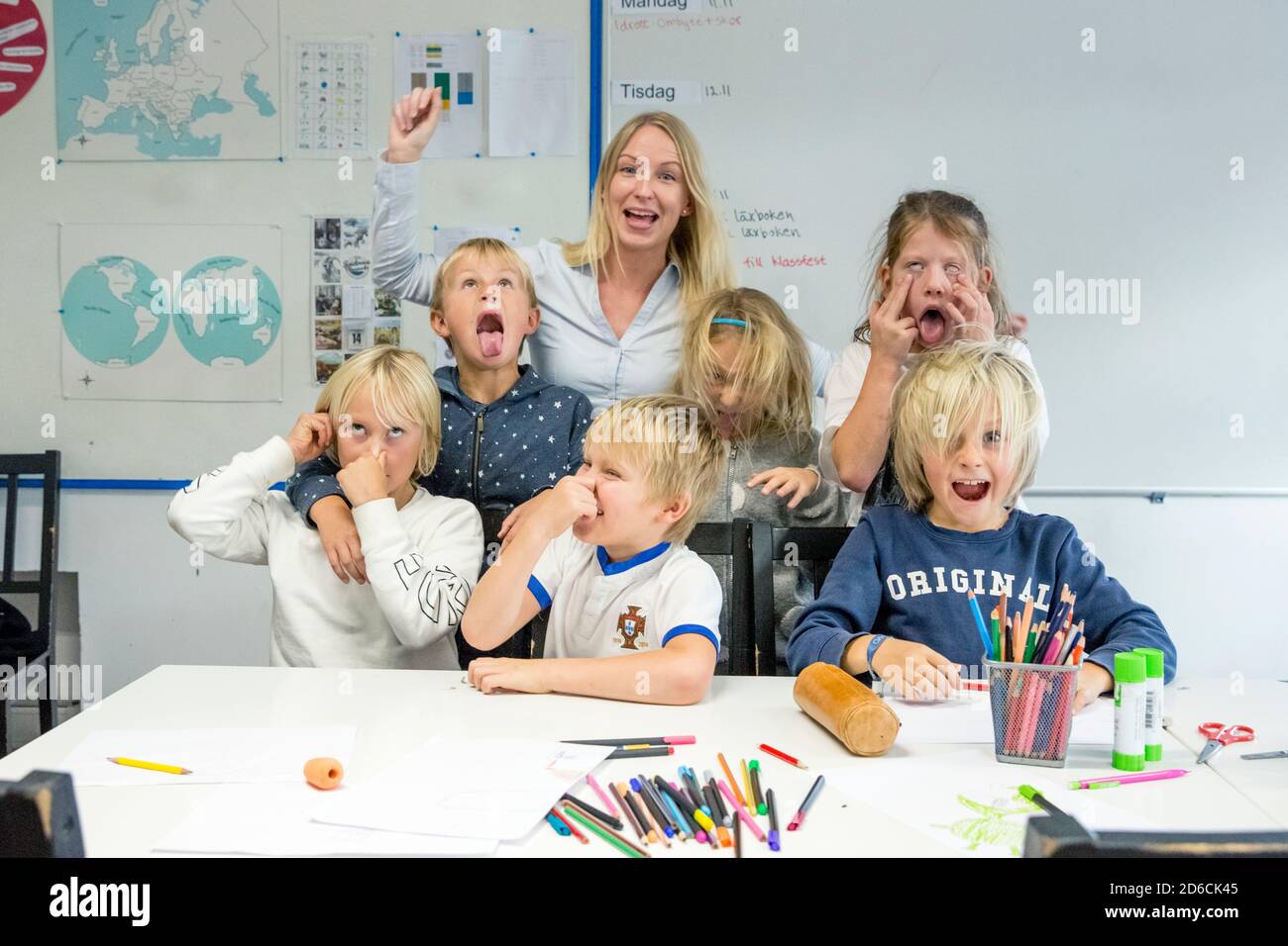 Teacher and children in classroom Stock Photo - Alamy