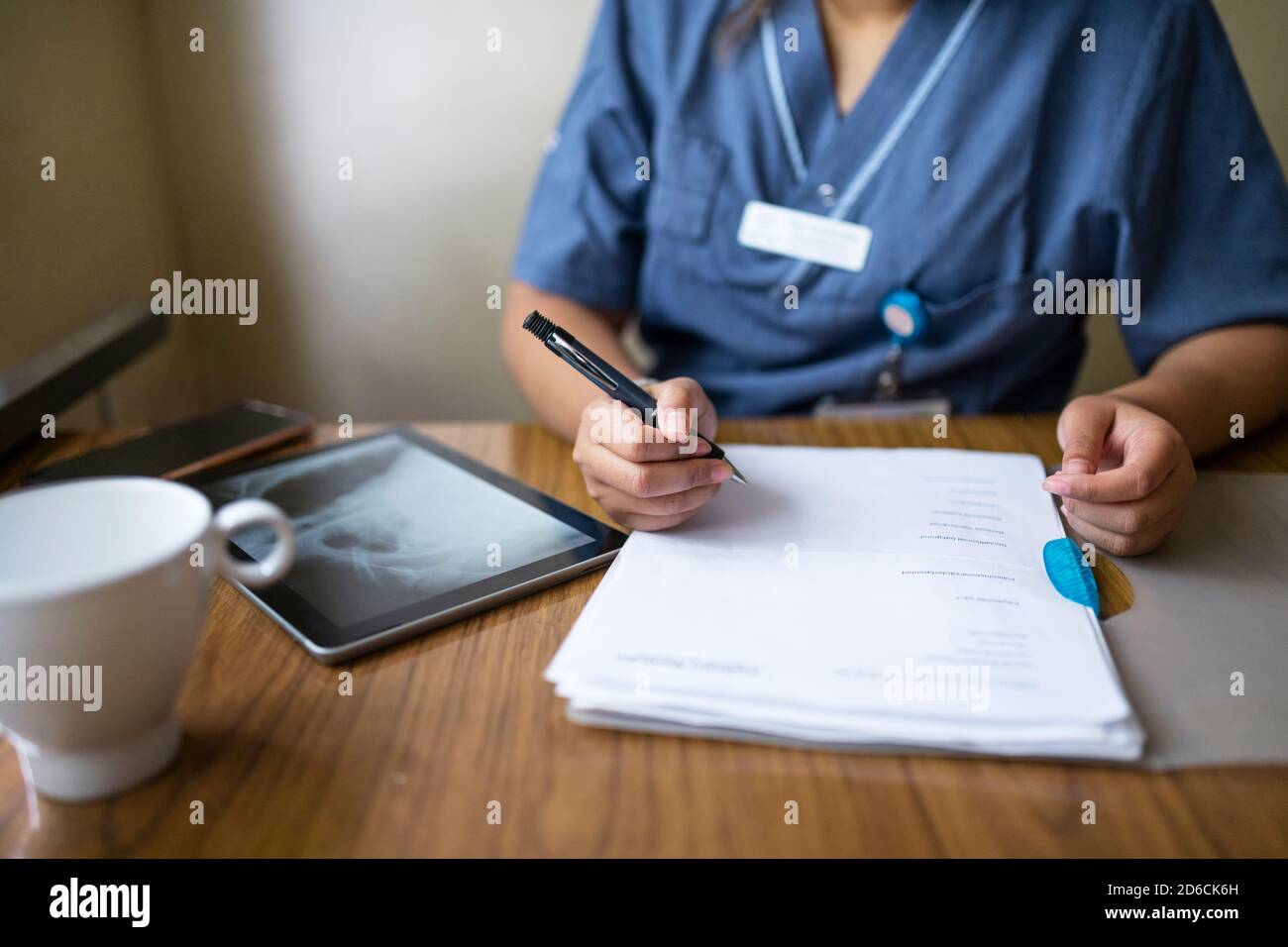 Nurse filling documents Stock Photo - Alamy
