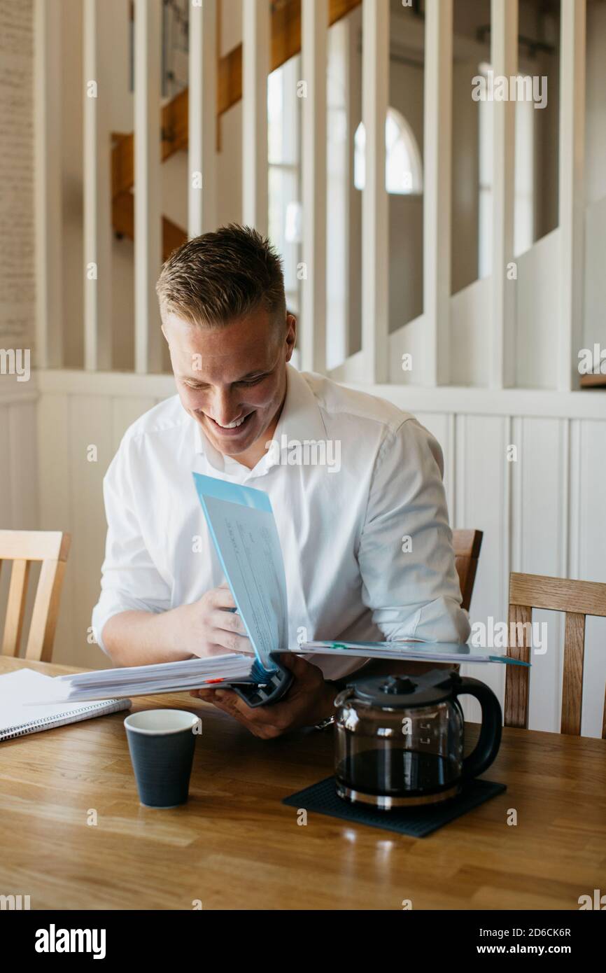 Sitting working holding looking down food and drink hi-res stock ...