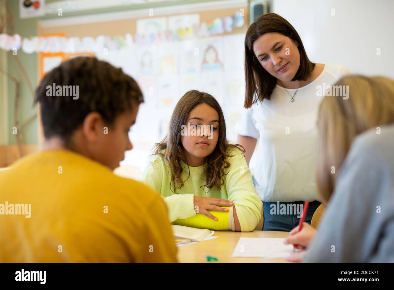 Teacher with children in classroom Stock Photo - Alamy