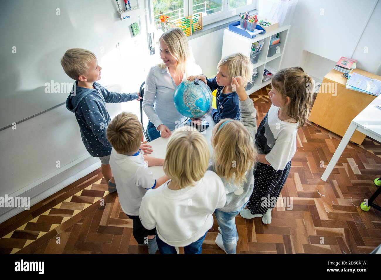 Teacher with children in classroom Stock Photo - Alamy