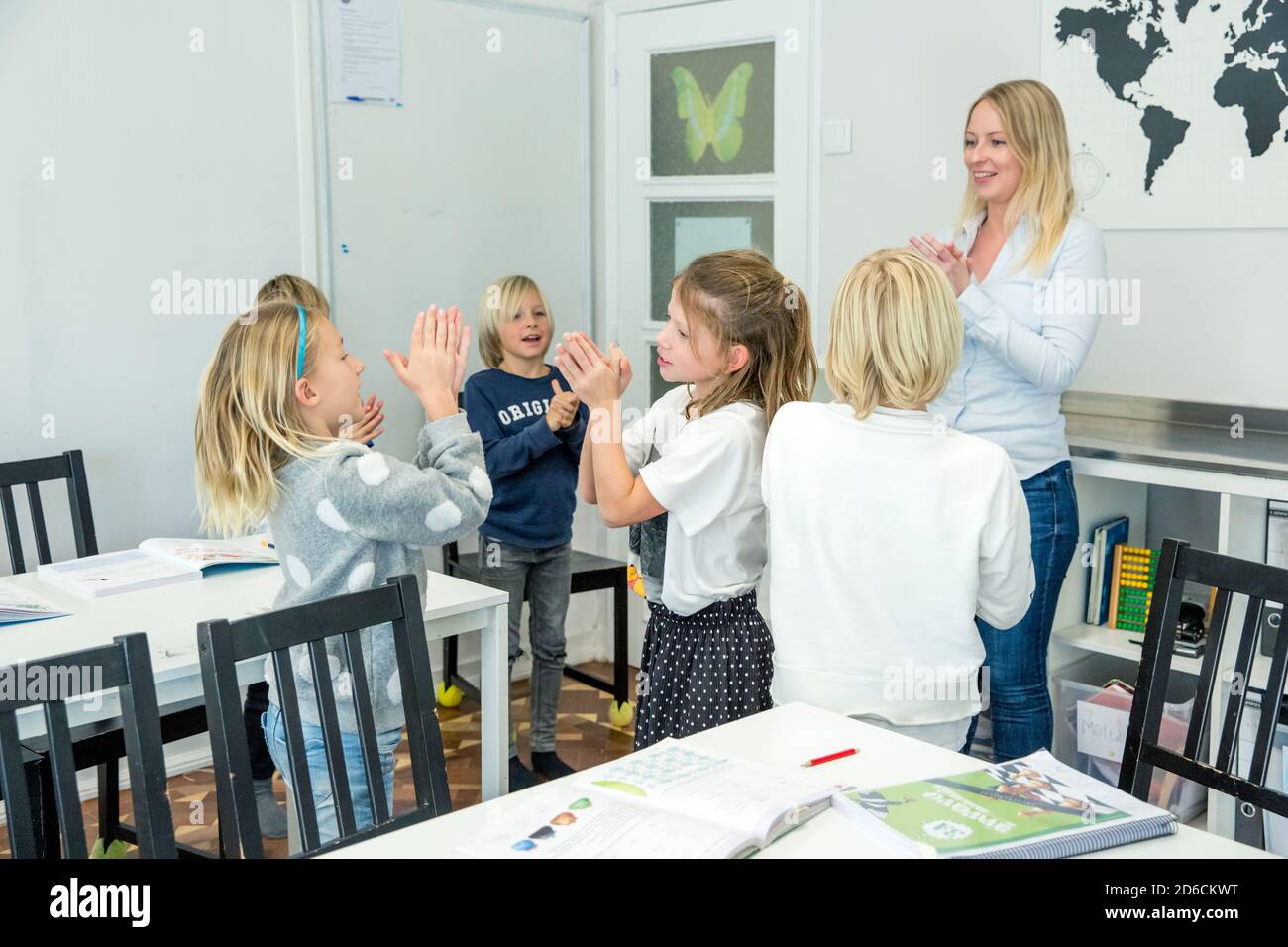 Teacher and children in classroom Stock Photo - Alamy