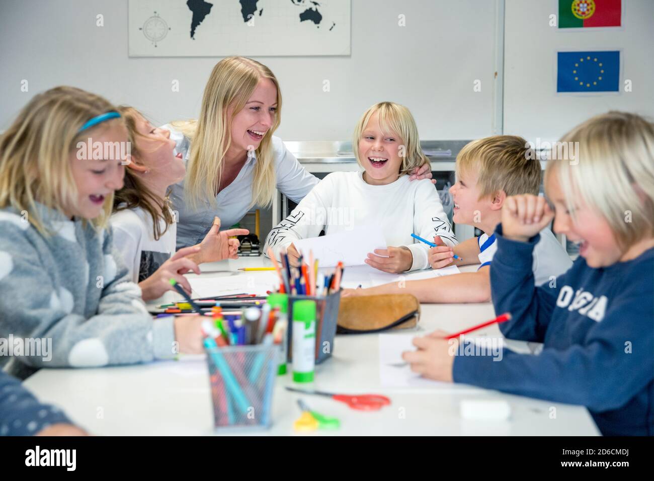Teacher and children in classroom Stock Photo - Alamy