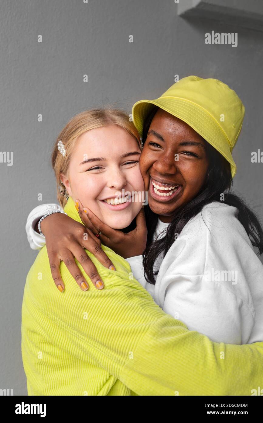Female friends hugging Stock Photo - Alamy