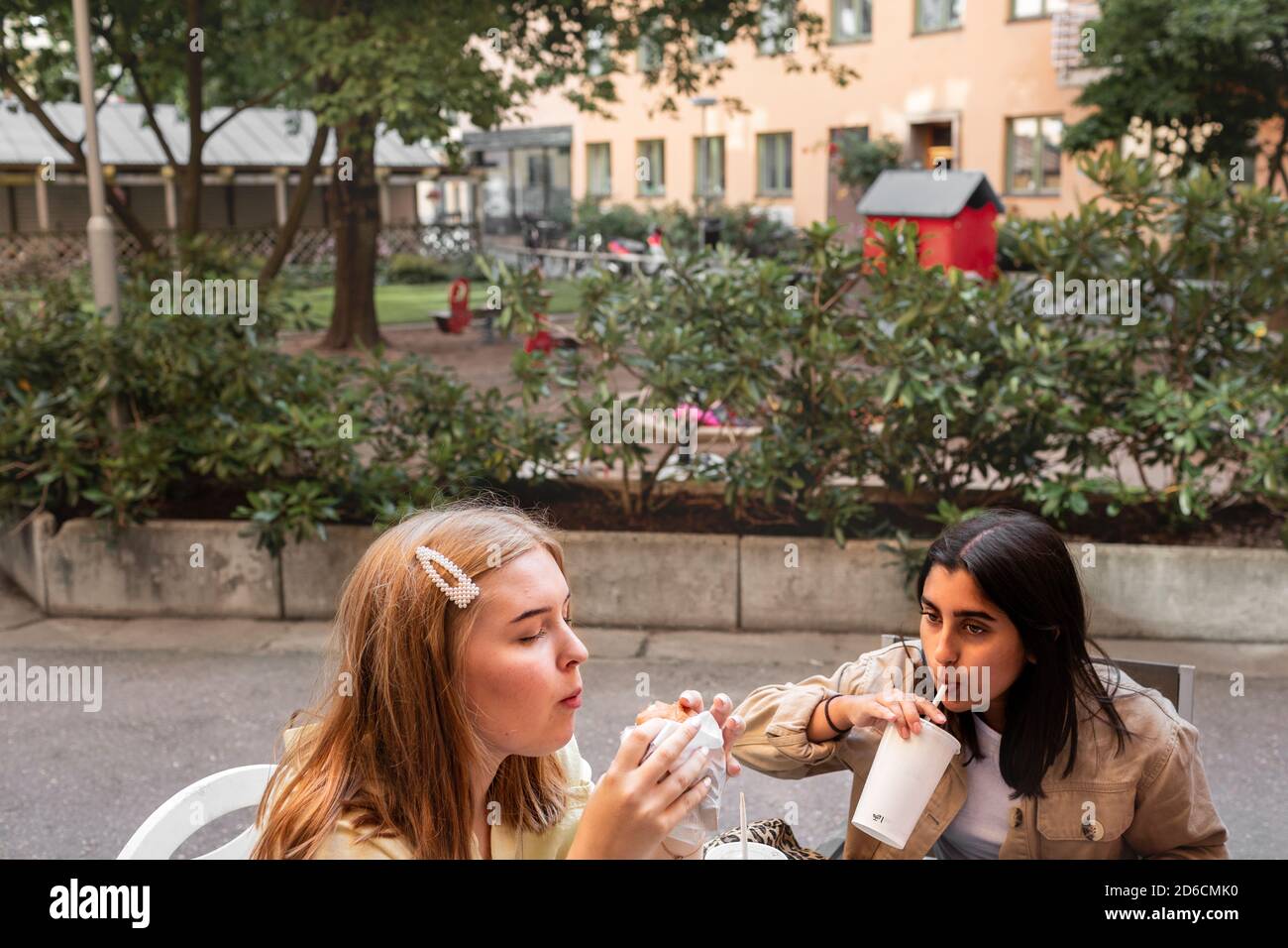 Young women eating fast food Stock Photo - Alamy
