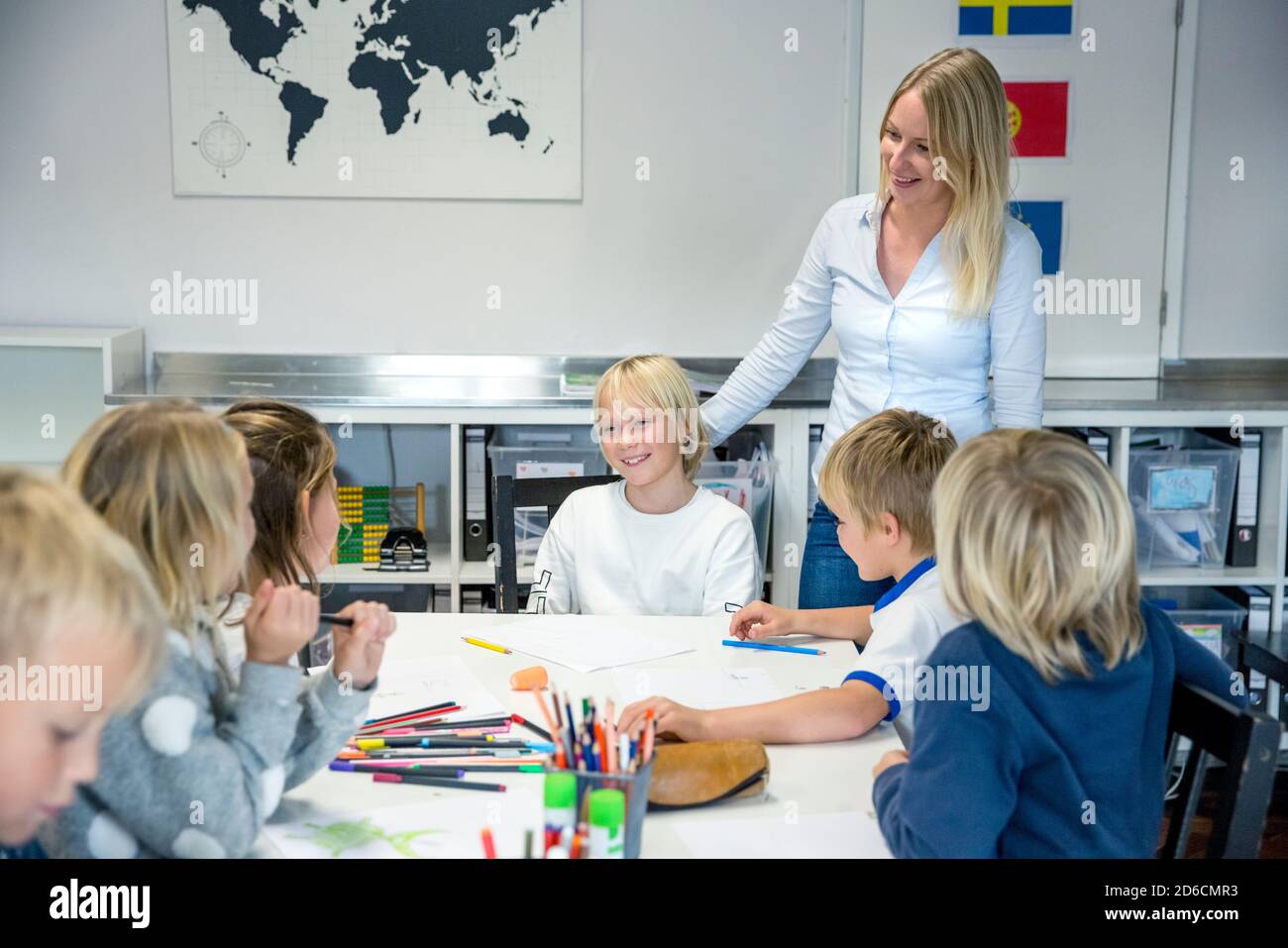 Teacher and children in classroom Stock Photo - Alamy