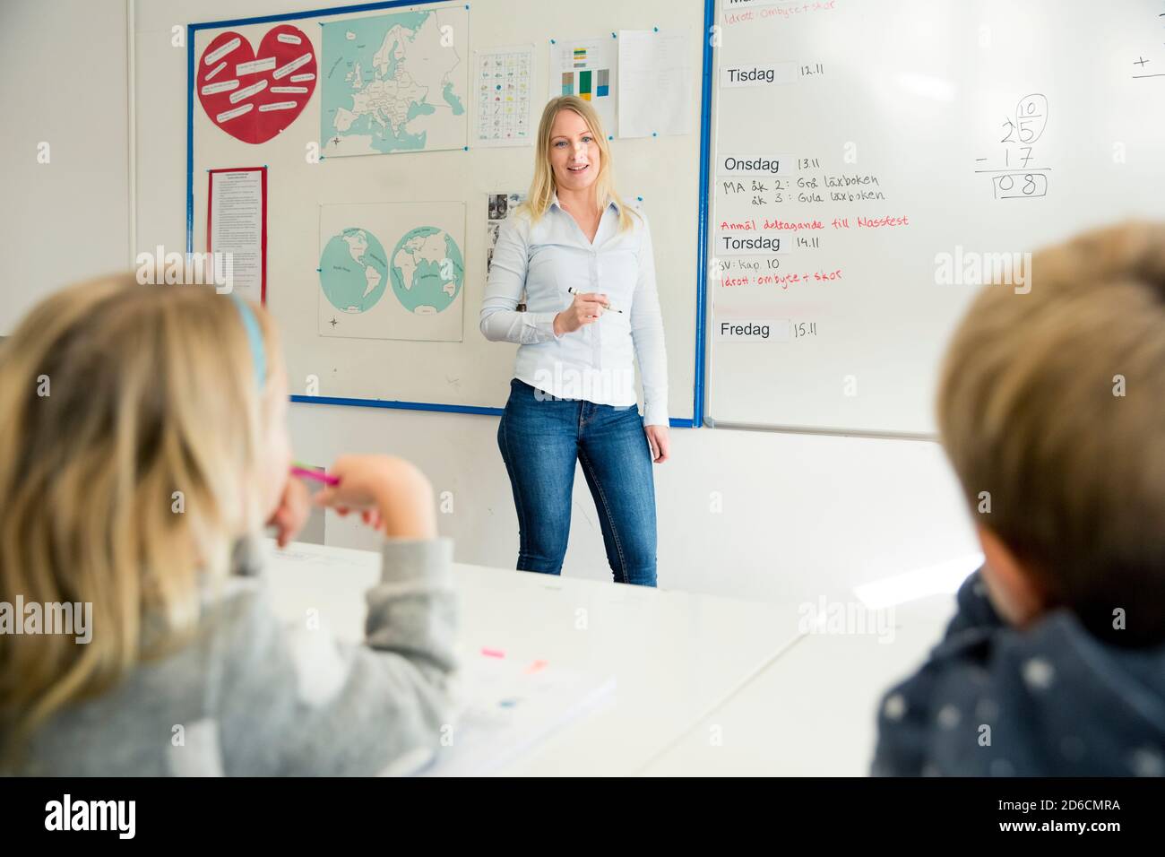 Teacher standing in classroom Stock Photo - Alamy