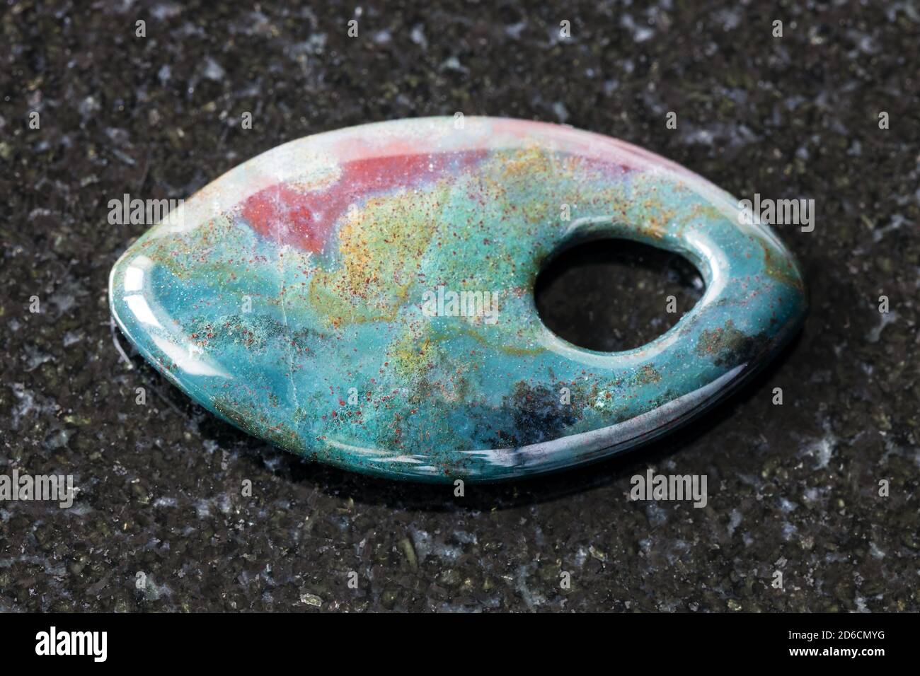 pendant from polished Heliotrope (Bloodstone) stone on black granite ...