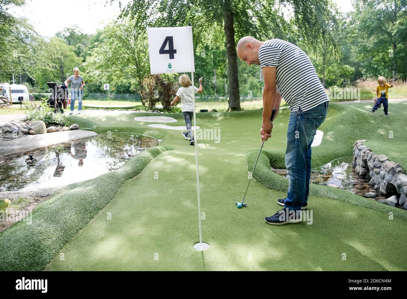 Man playing mini golf Stock Photo - Alamy