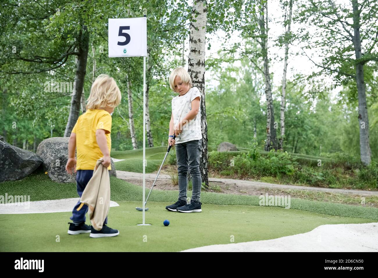 Boys playing mini golf Stock Photo - Alamy