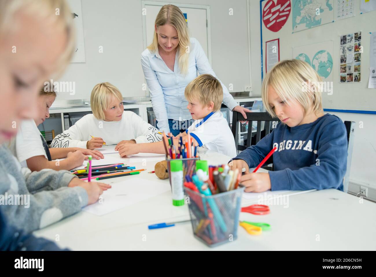 Teacher with children in classroom Stock Photo - Alamy