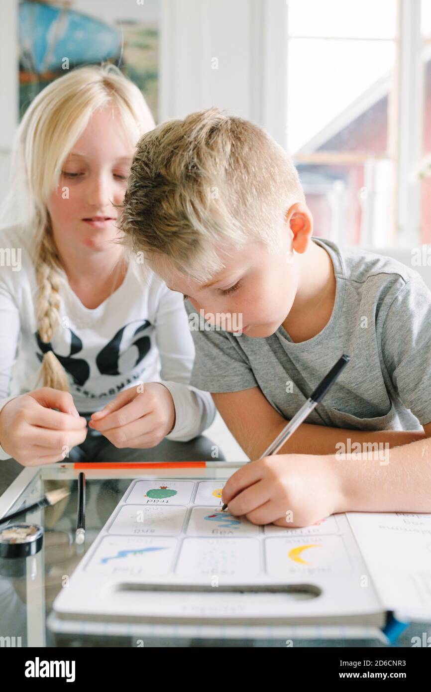 Brother and sister writing hi-res stock photography and images - Alamy
