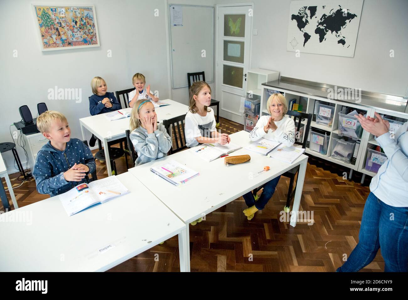 Teacher and children in classroom Stock Photo - Alamy