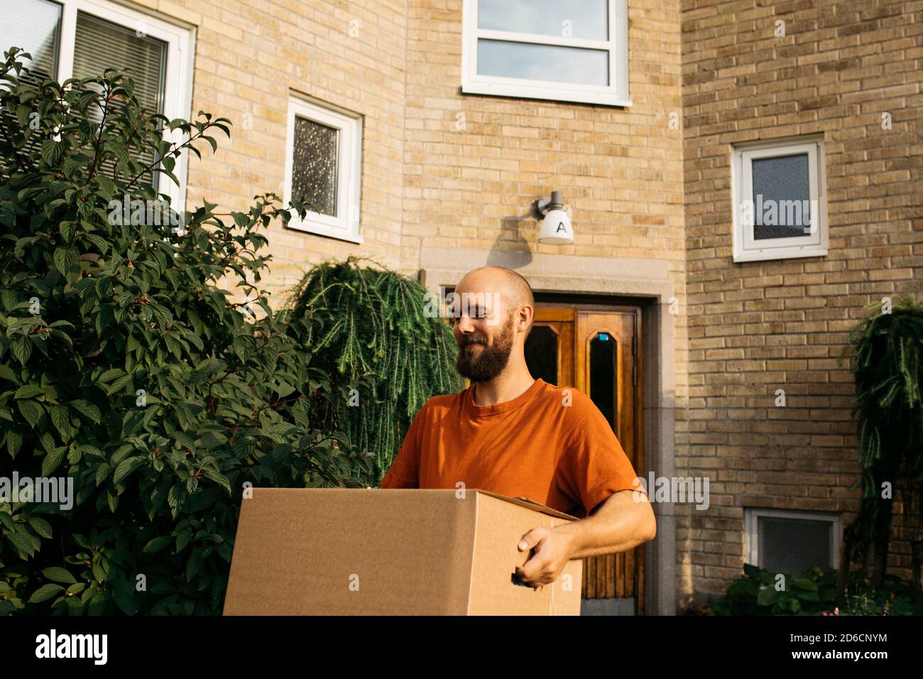 Man carrying cardboard box Stock Photo - Alamy
