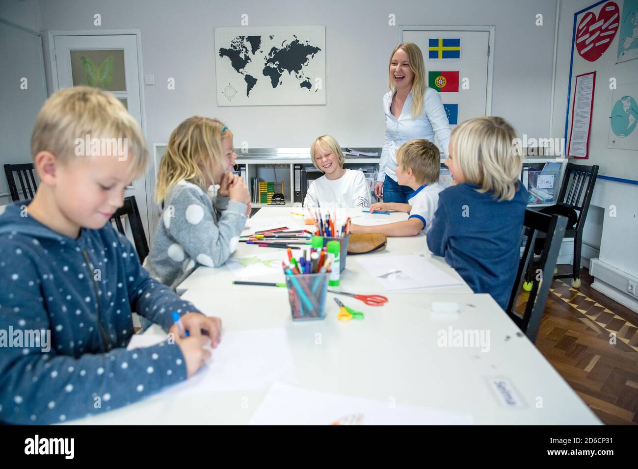 Teacher and children in classroom Stock Photo - Alamy