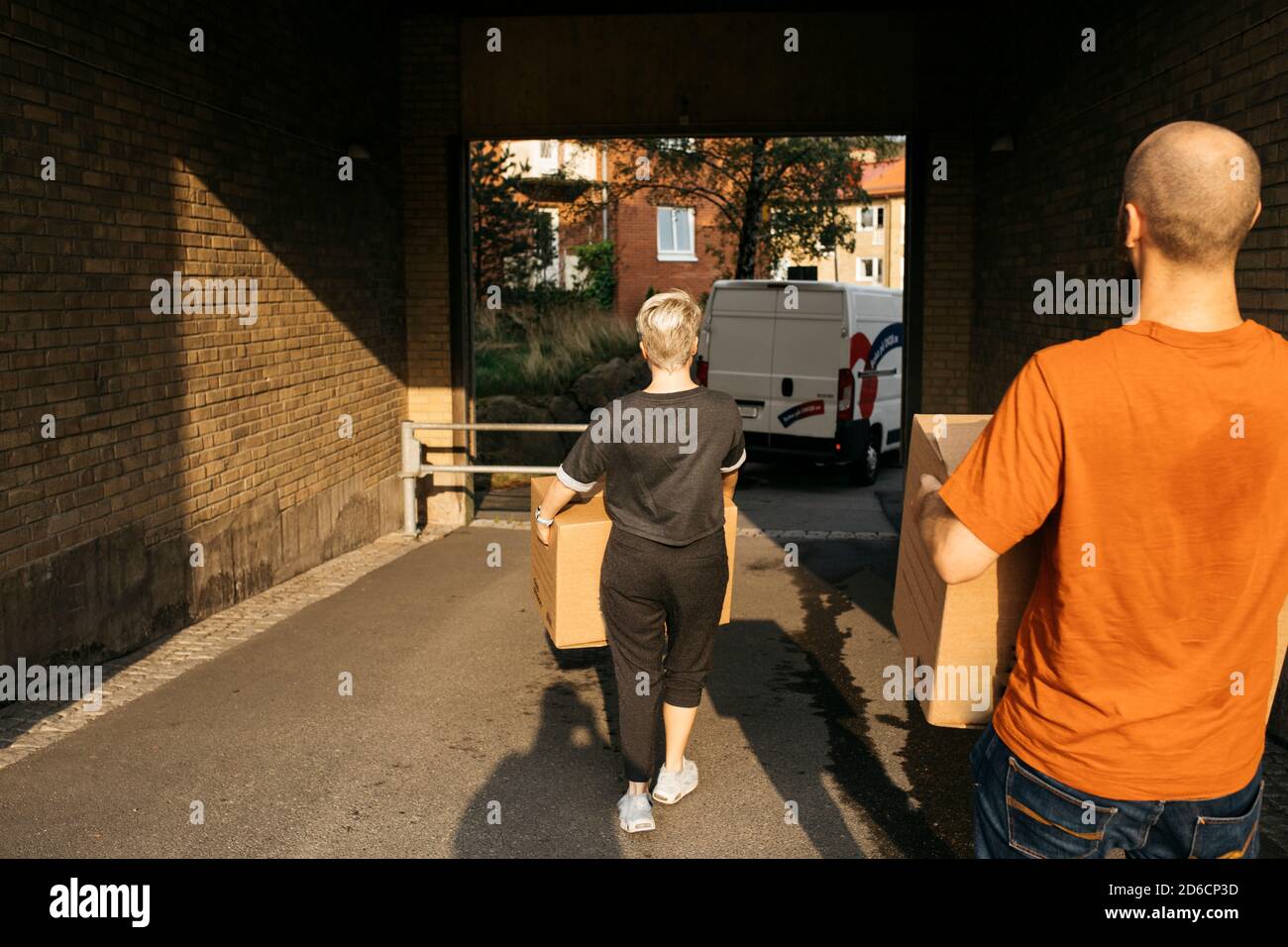 People carrying cardboard boxes Stock Photo - Alamy