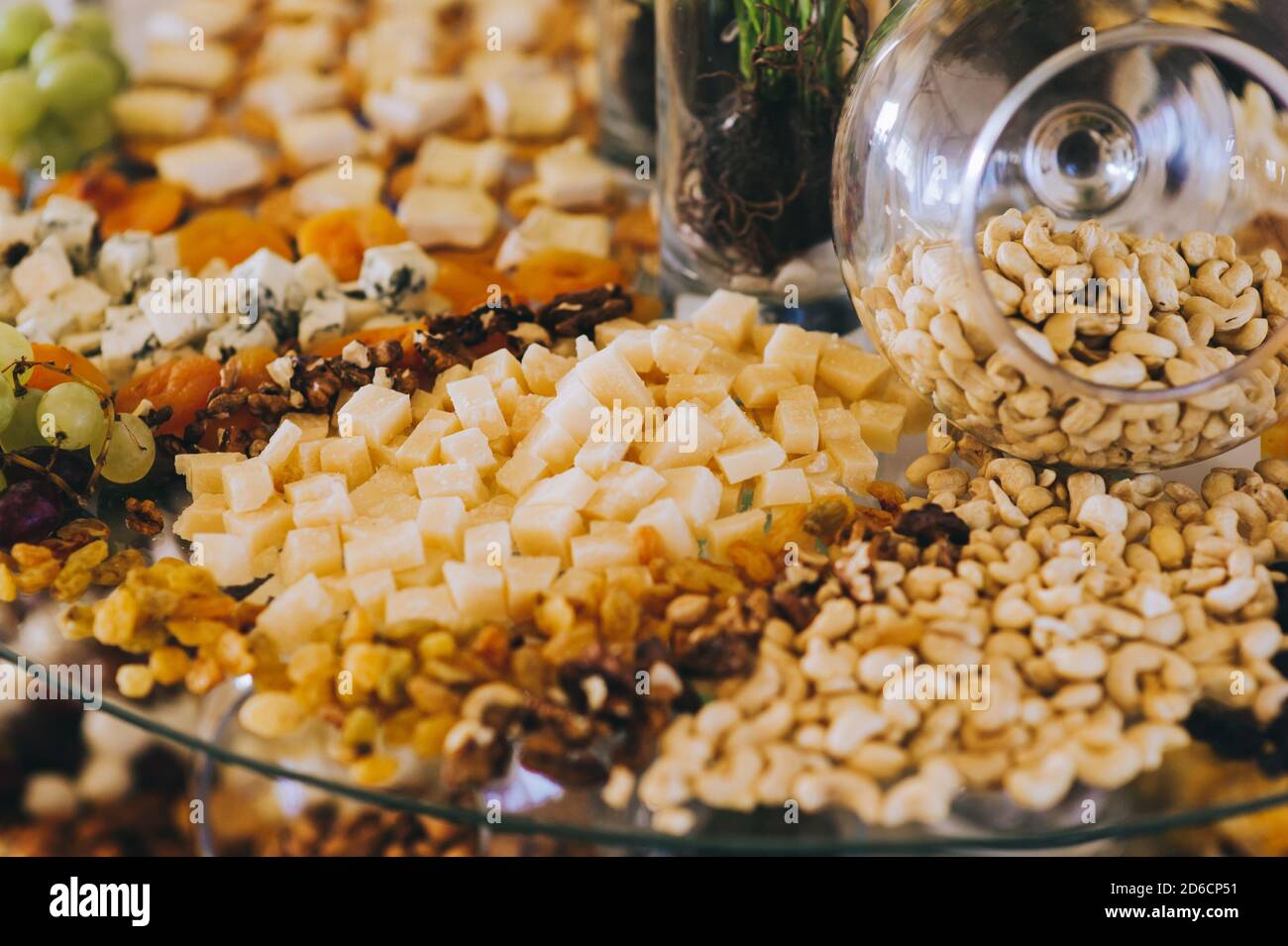 Close up of various types of cheese, nuts and peanuts on a banquet ...