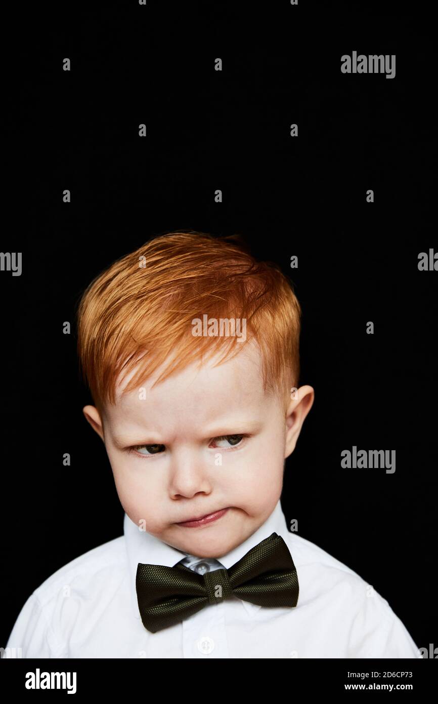 Portrait of boy frowning Stock Photo - Alamy