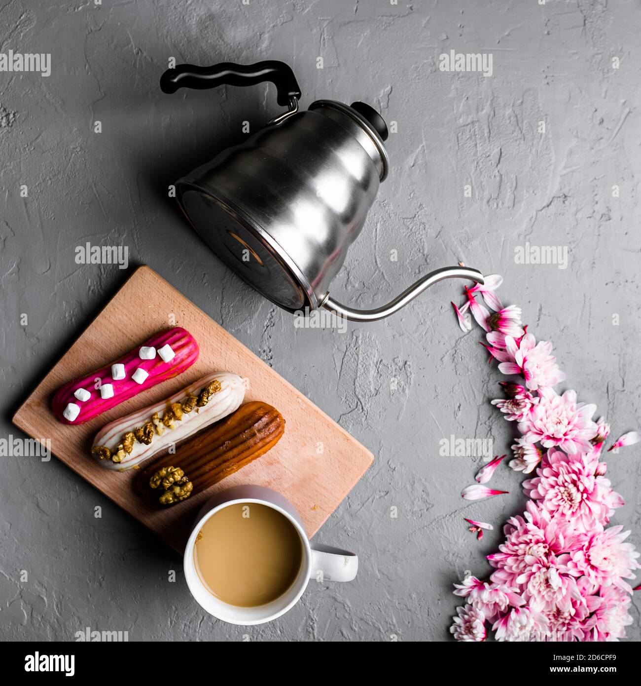 Creative layout of teapot with chrysanthemum flowers on gray concrete ...