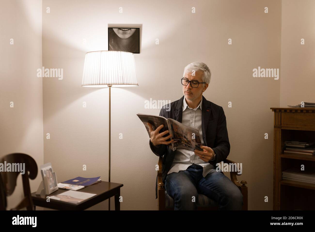 Man reading magazine Stock Photo - Alamy