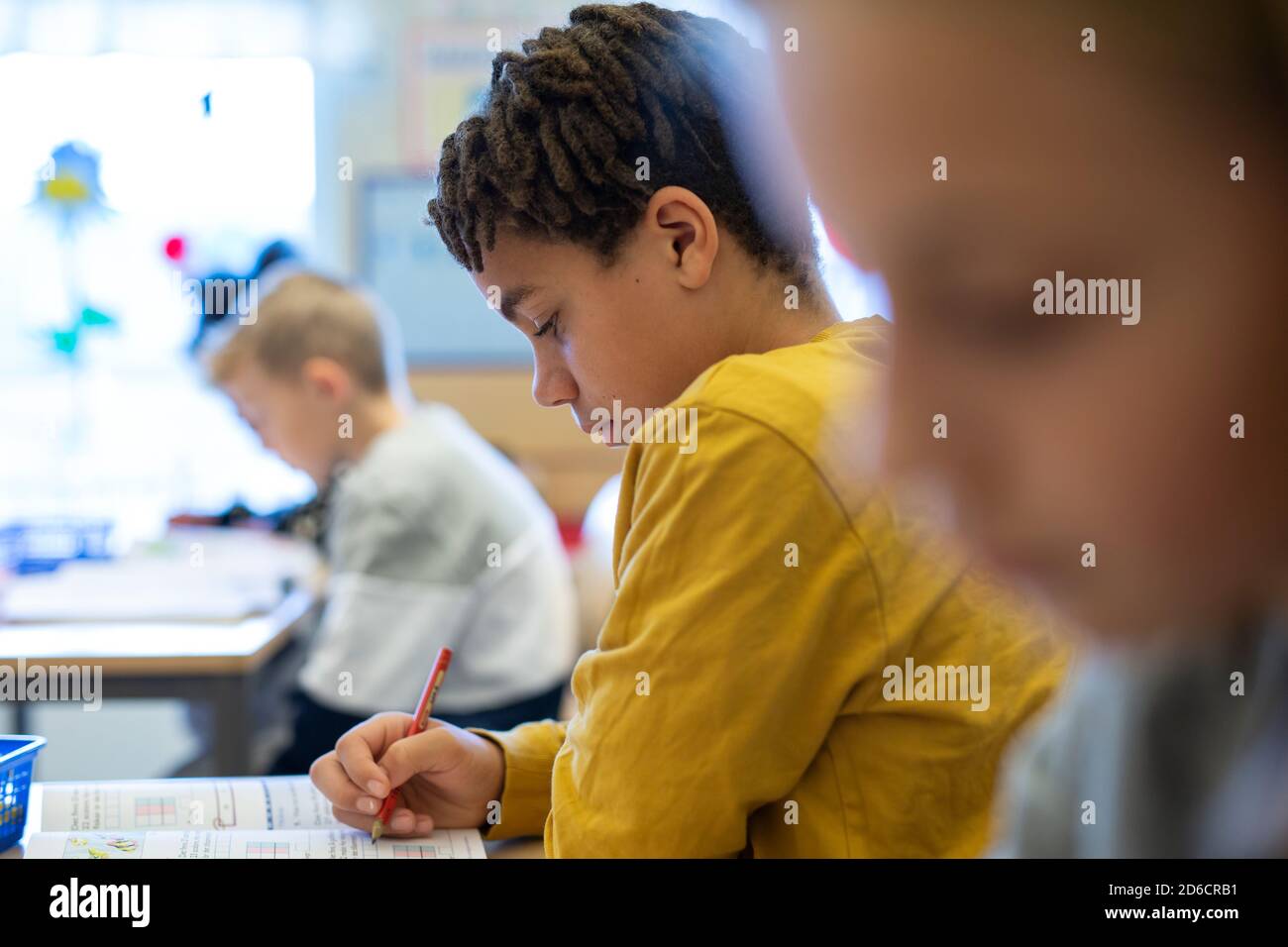 Boy in classroom Stock Photo - Alamy