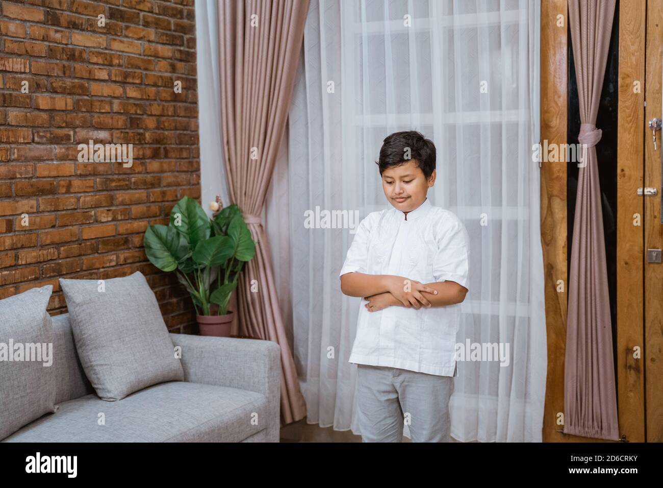 Little Muslim kid is praying on a traditional way in the house Stock ...