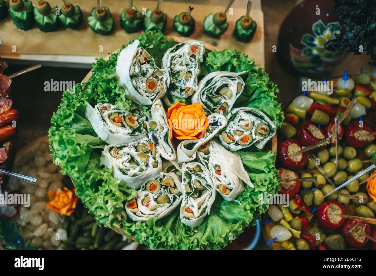 Top view of a round wooden board with chopped stuffed pita lying on a ...