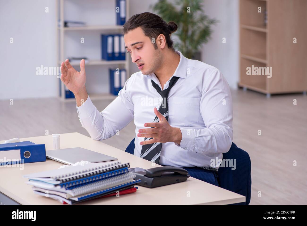 Male employee suffering at workplace Stock Photo - Alamy