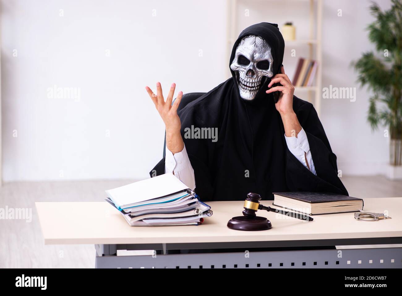 Devil judge working in the courthouse Stock Photo - Alamy