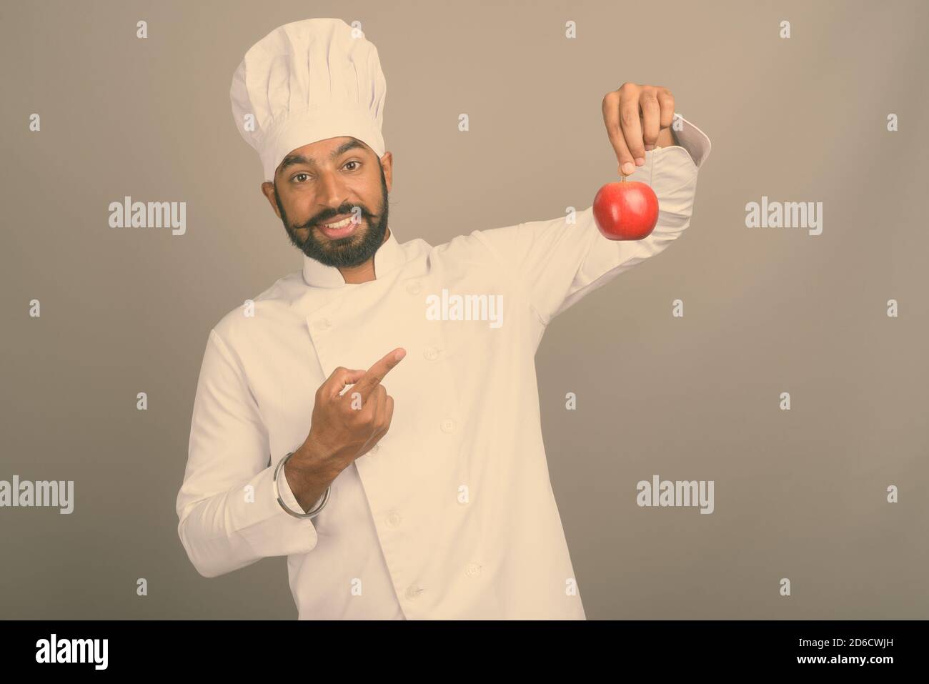 Young handsome Indian man chef against gray background Stock Photo - Alamy