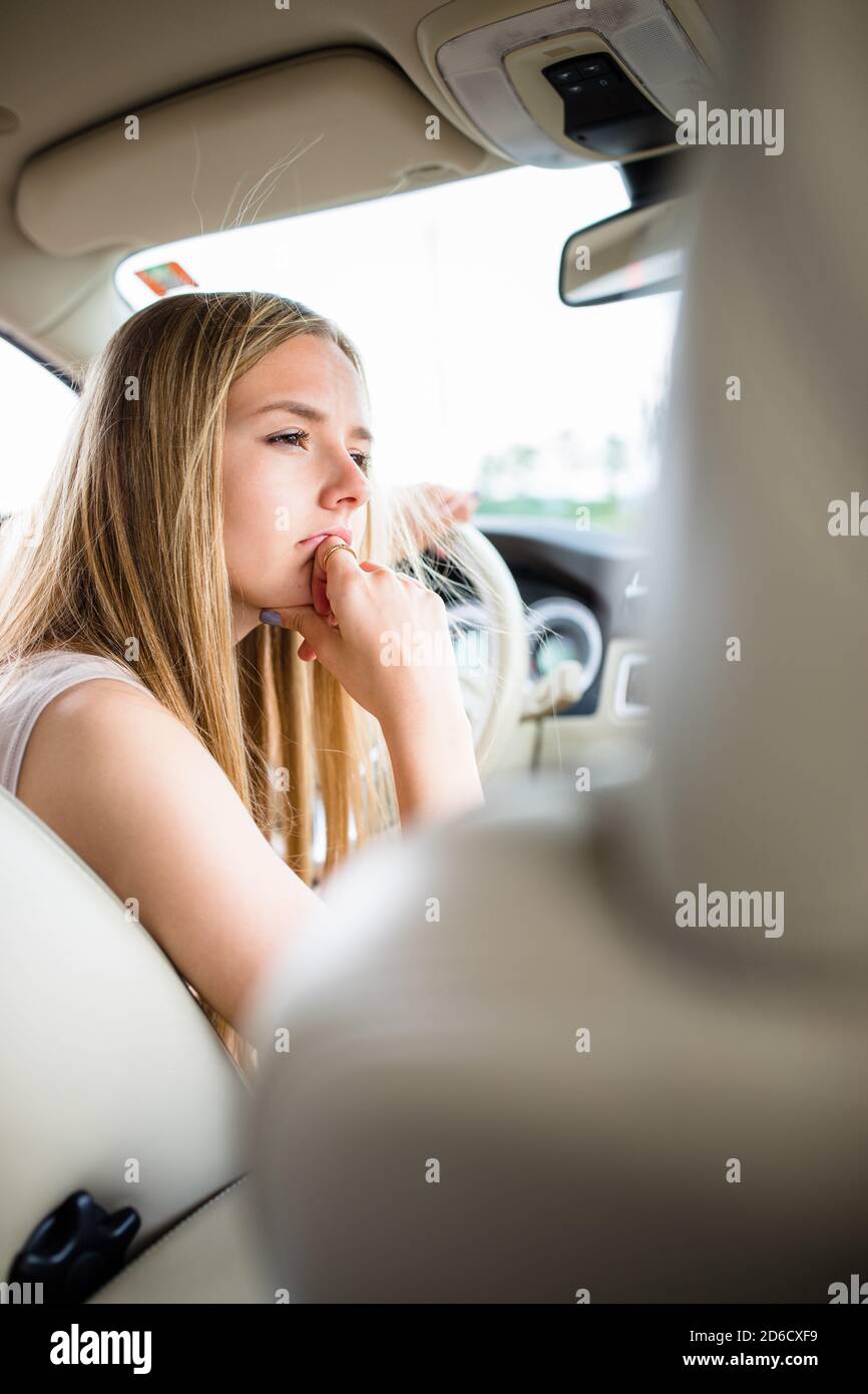 Cute female teen driver enjoying her freshly acquired driving license ...