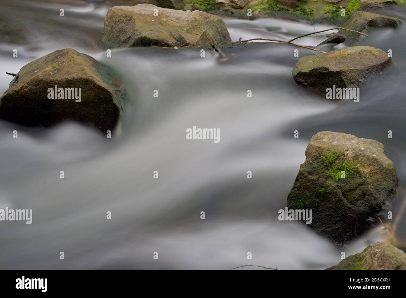 River flowing around stones Stock Photo - Alamy