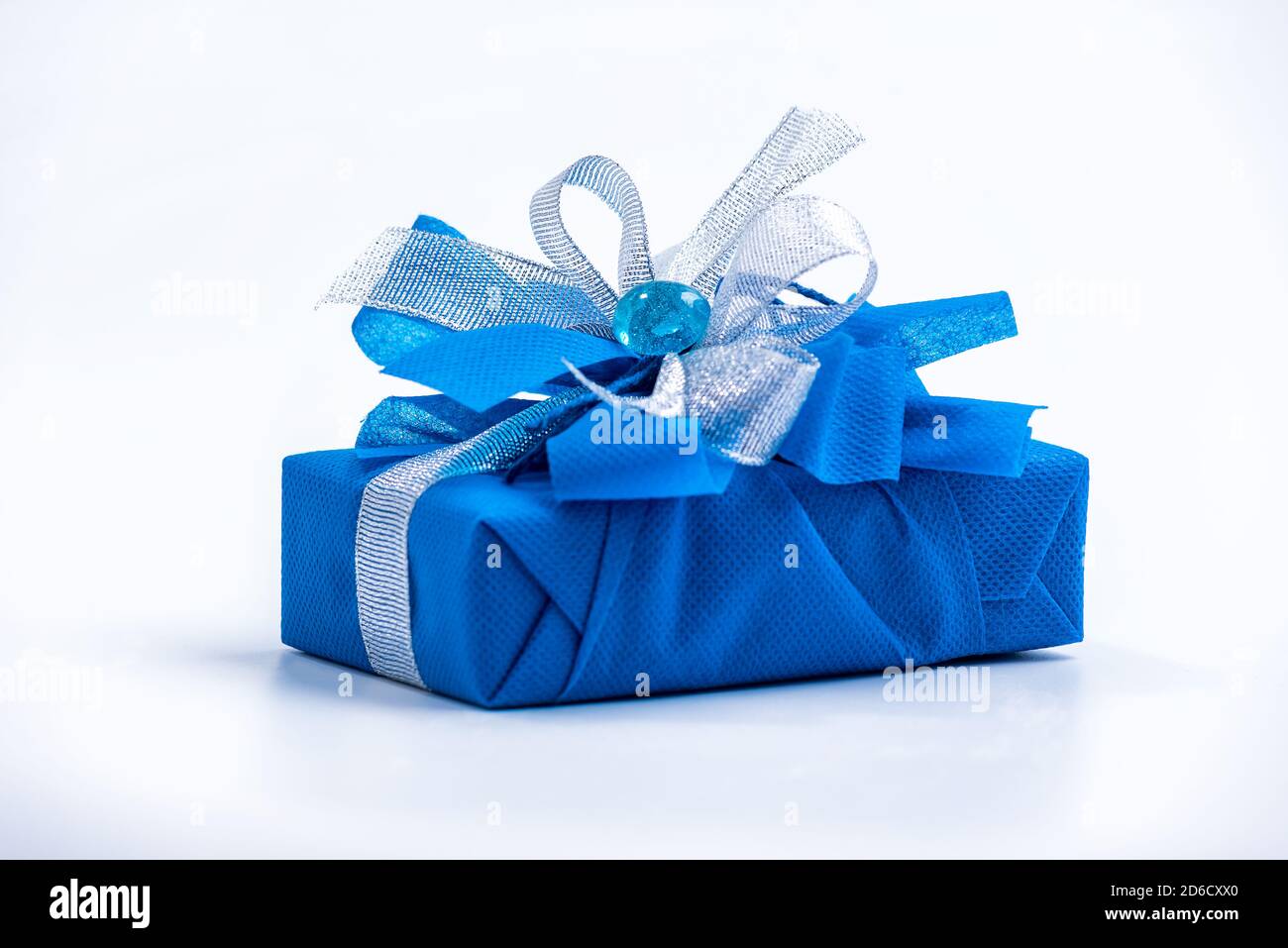 Classic blue surprise gift box with blue and white ribbon, background ...