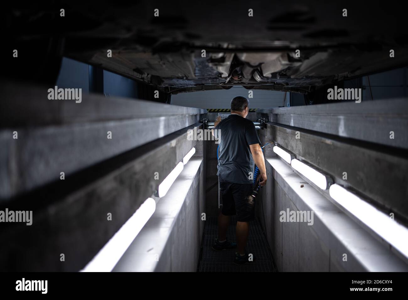 Car mechanic changind tires of a car in a repair shop/car garage ...