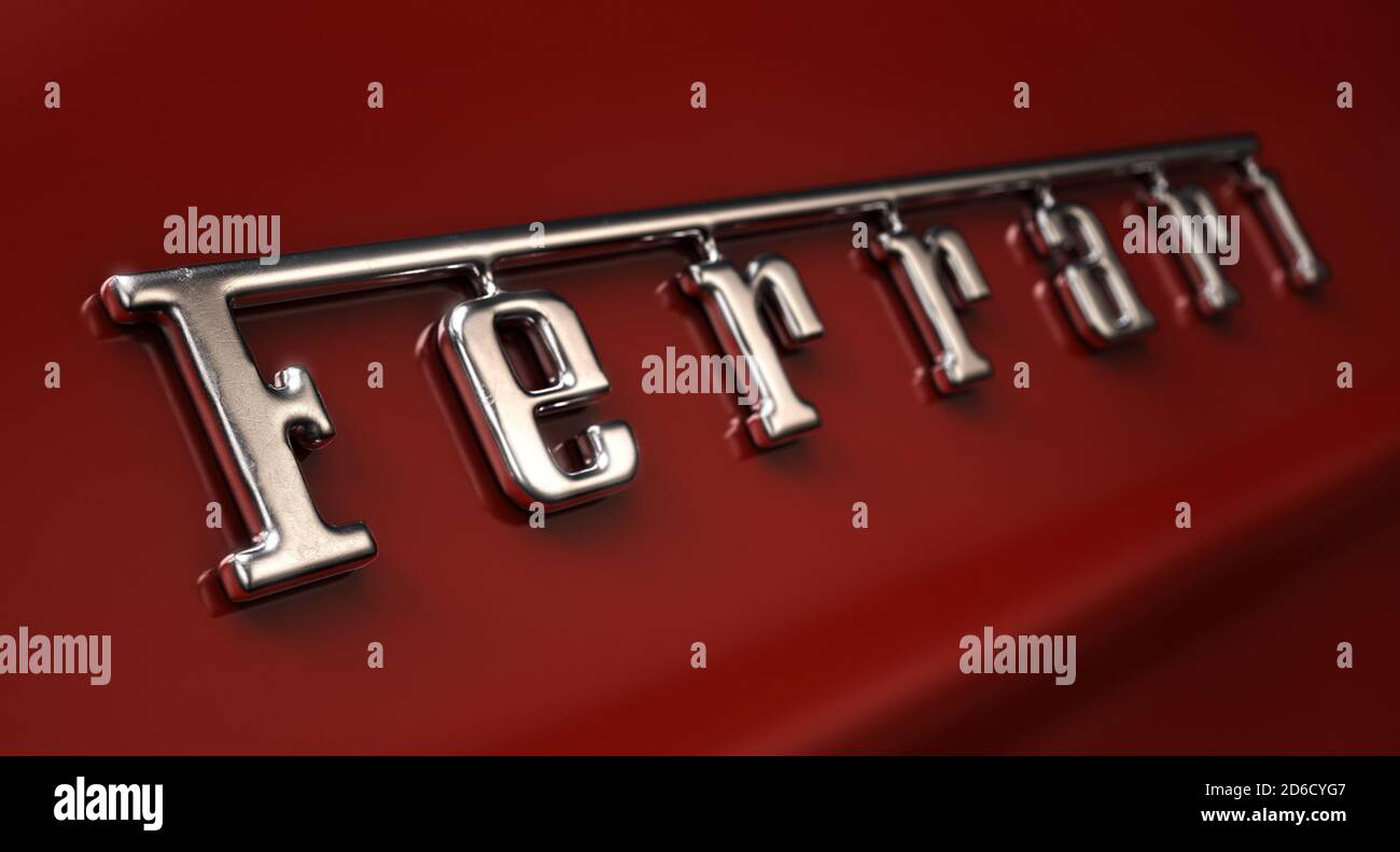A closeup of a classic vintage ferrari chrome decal emblem on a car ...
