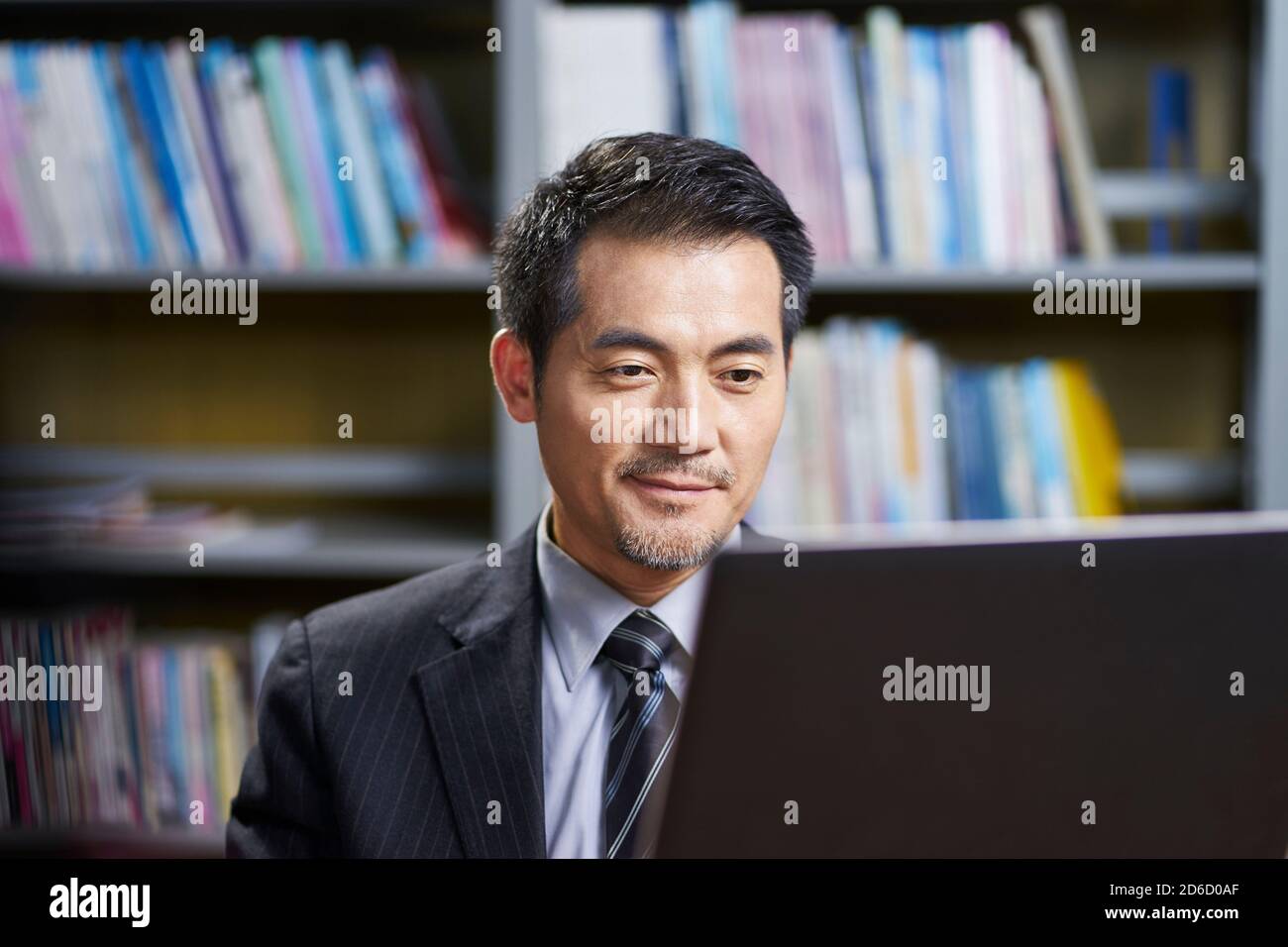 asian corporate executive working in office using laptop computer Stock ...