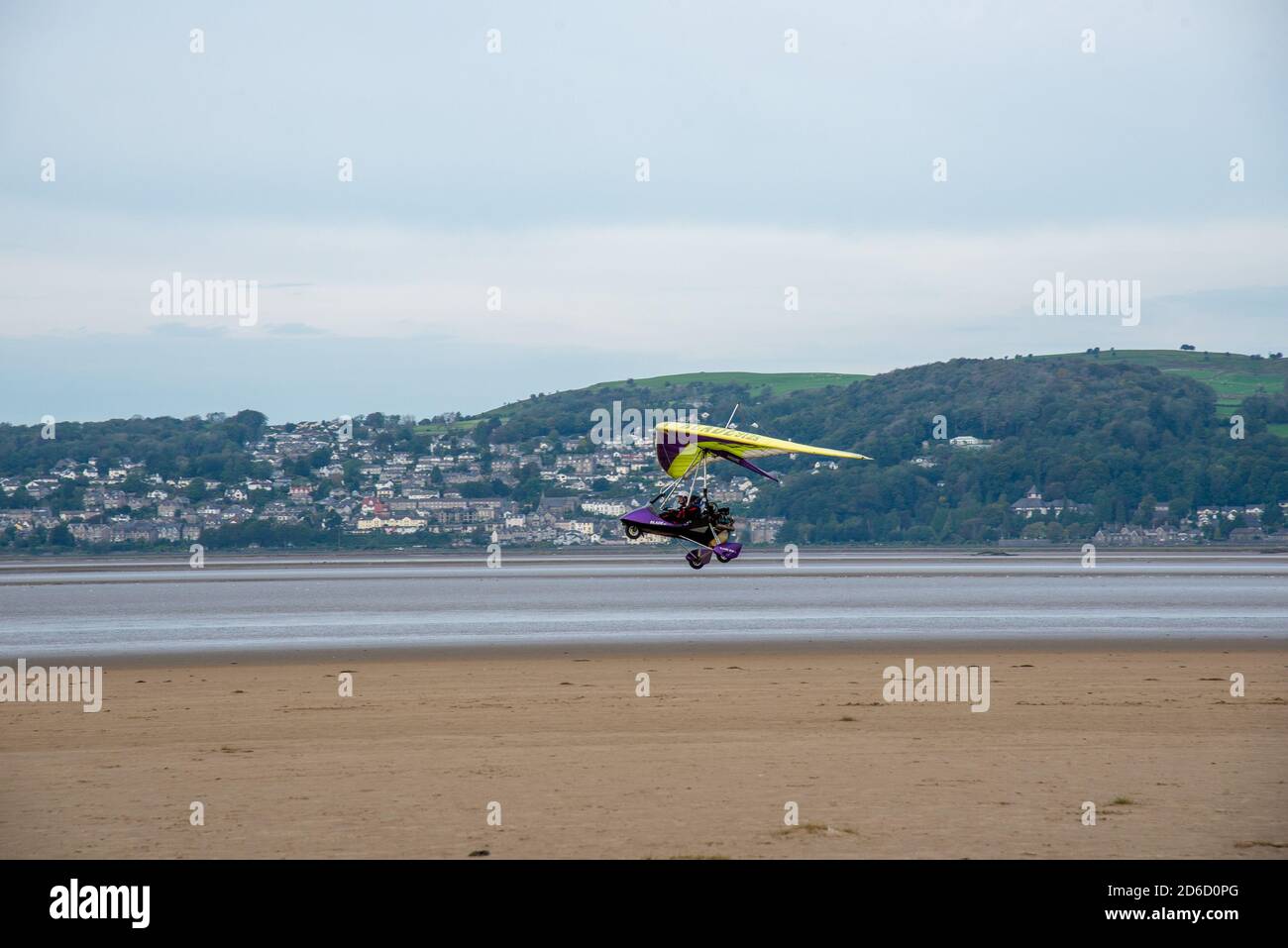 A microlight aircraft taking off on the beach at Arnside, Cumbria. UK ...