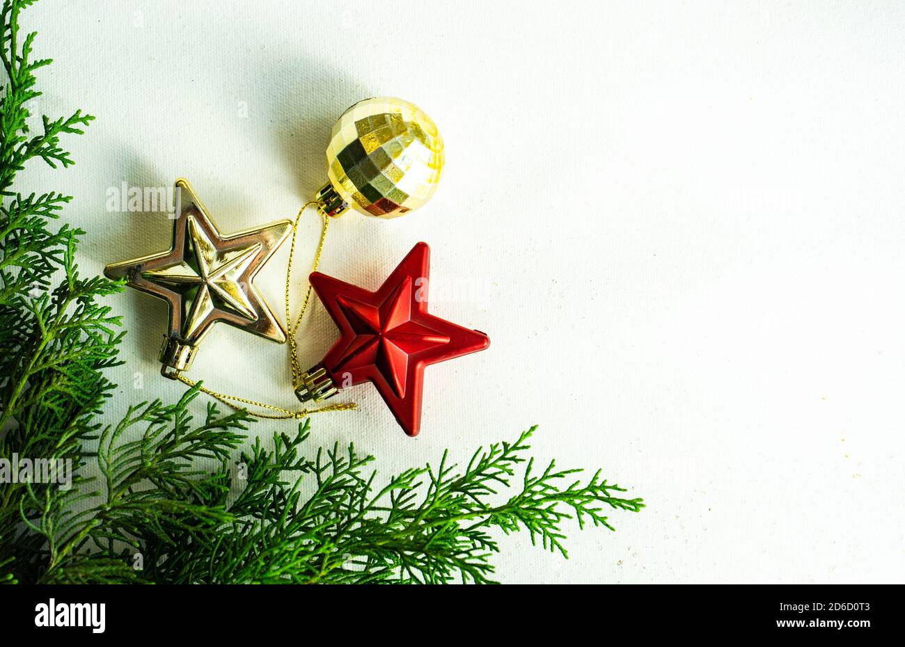 Christmas card concept with evergreen plant and star shaped baubles on ...