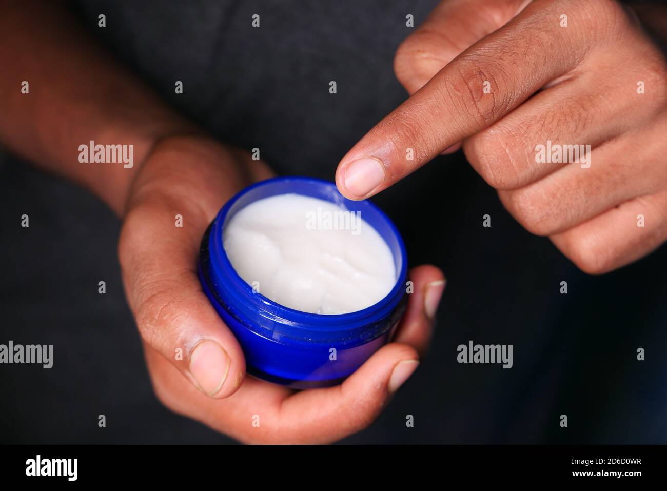 man applying beauty cream onto skin at home top view Stock Photo - Alamy
