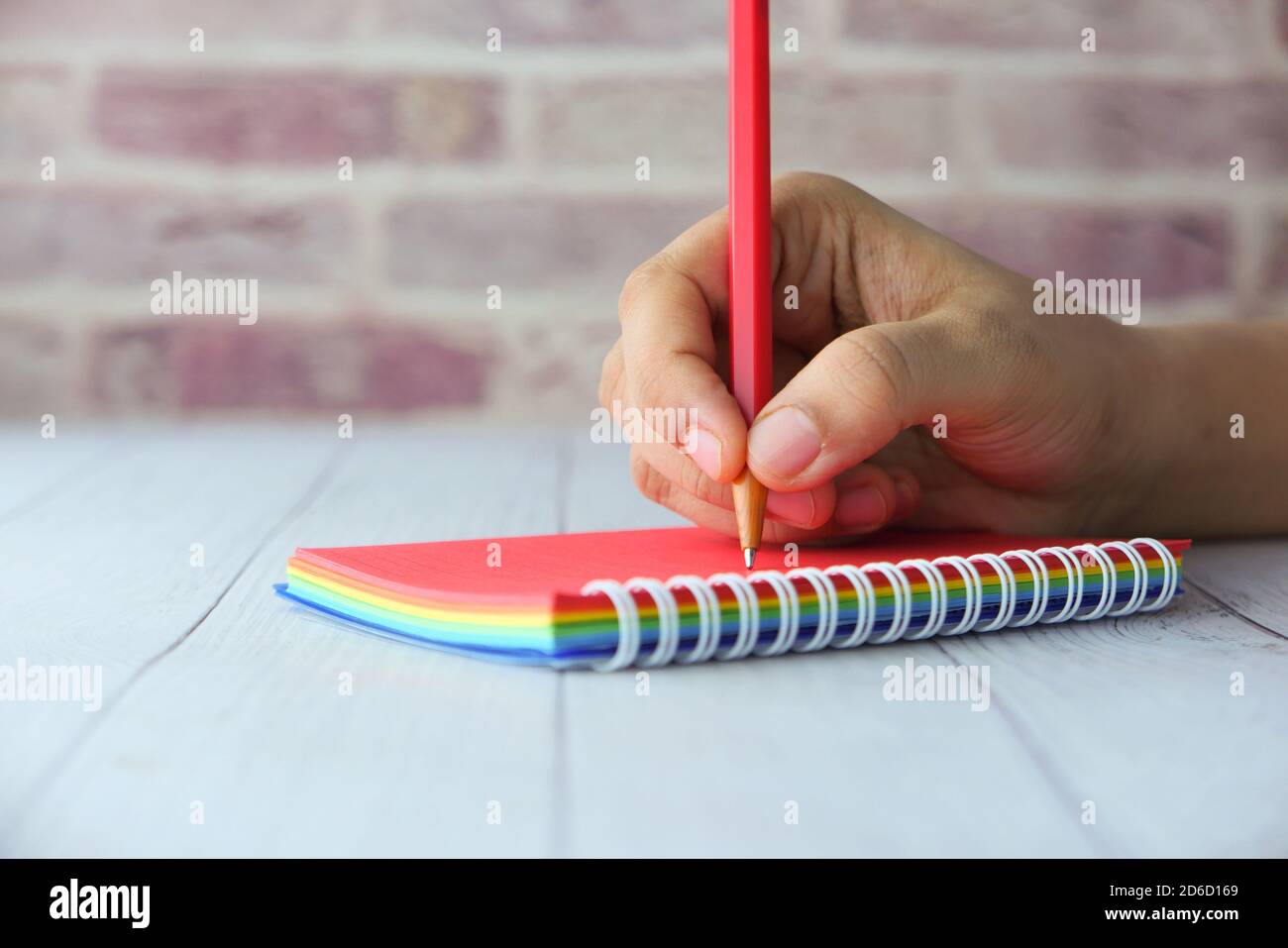 Close up of women hand writing on notepad Stock Photo - Alamy