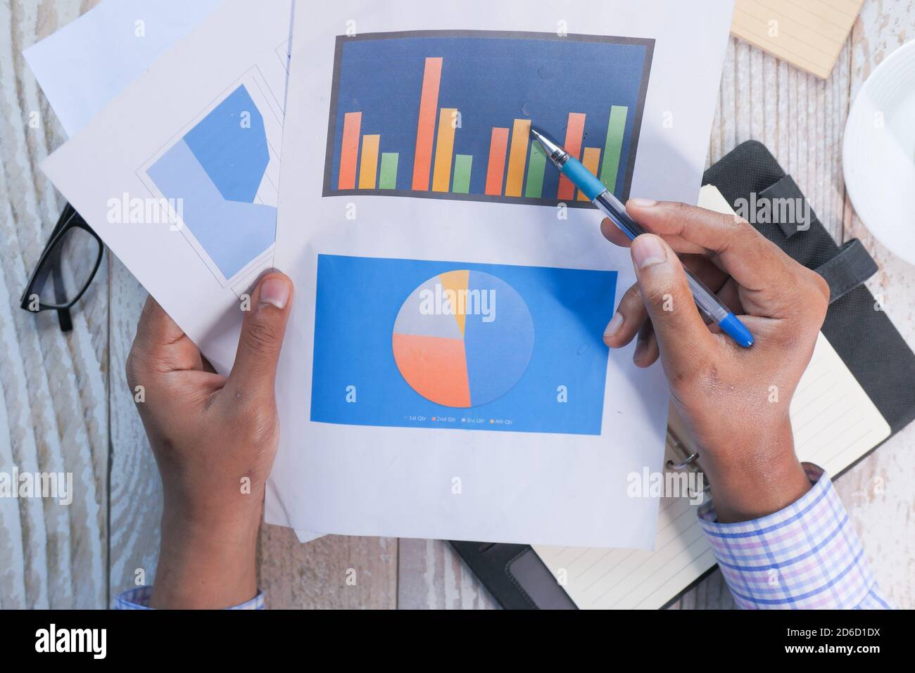 top view of man hand with pen analyzing bar chart on paper Stock Photo ...