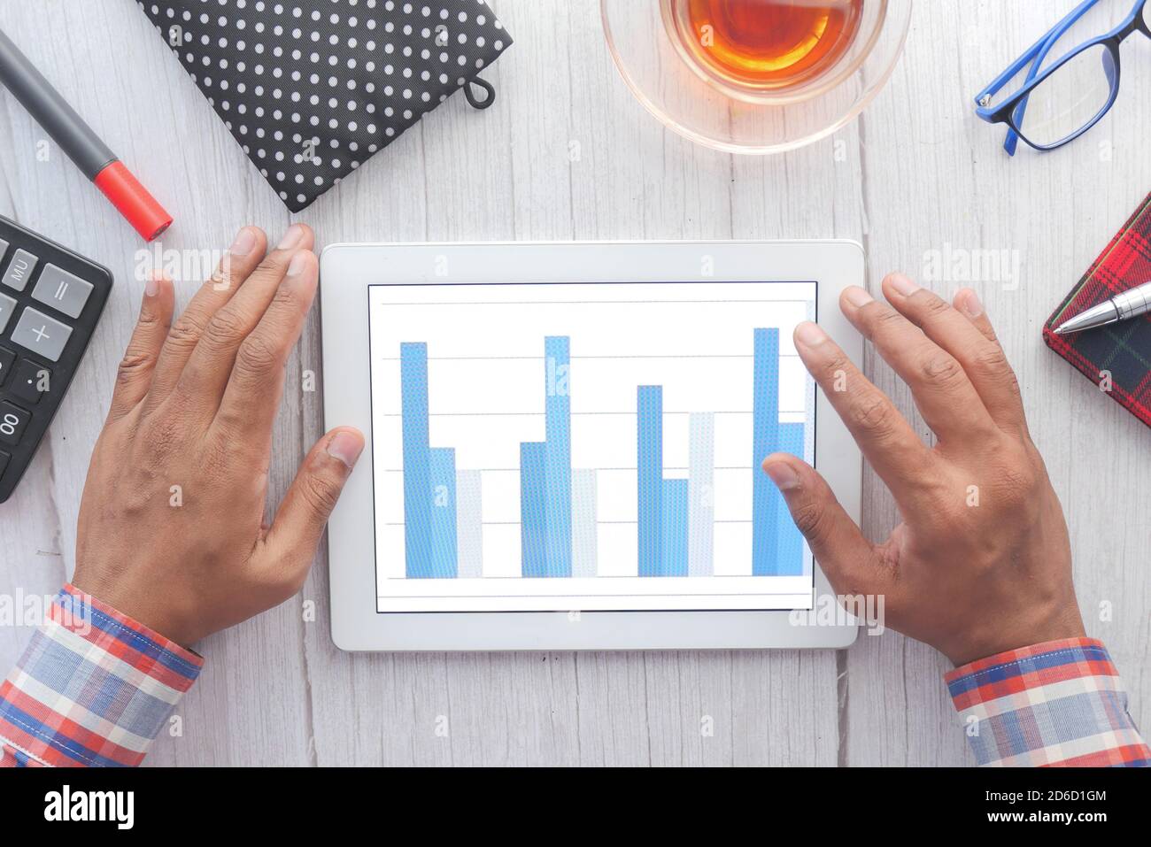 man's hand working on digital tablet at office desk, using self created ...