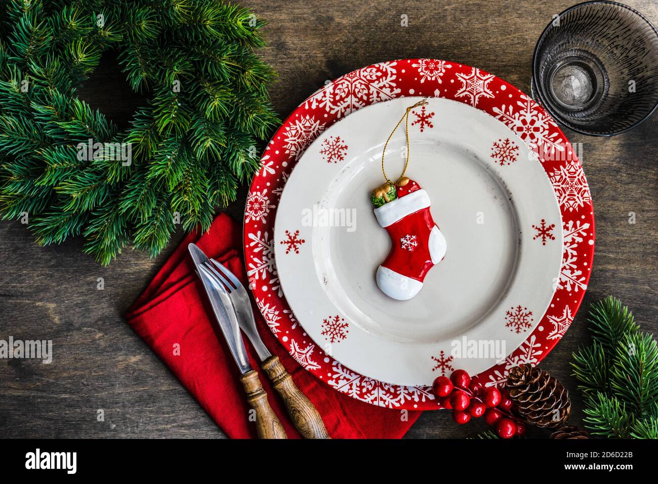 Empty plate with festive decor and cutlery on table fot Christmas ...
