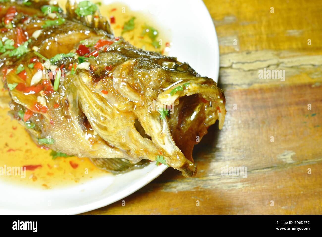 deep fried red banded grouper fish dressing sweet chili sauce on plate ...
