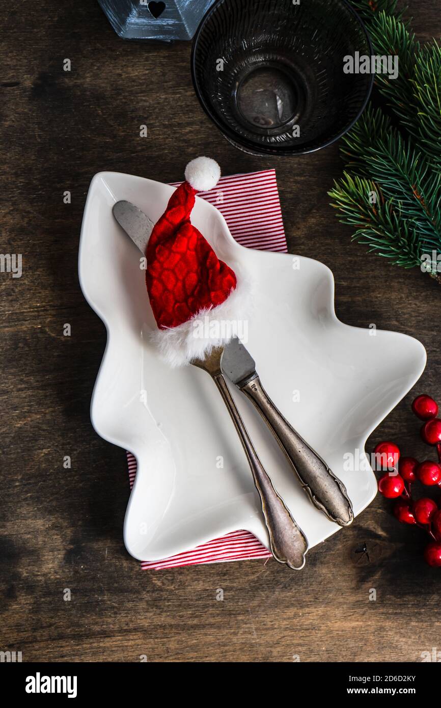 Empty plate with festive decor and cutlery on table fot Christmas ...